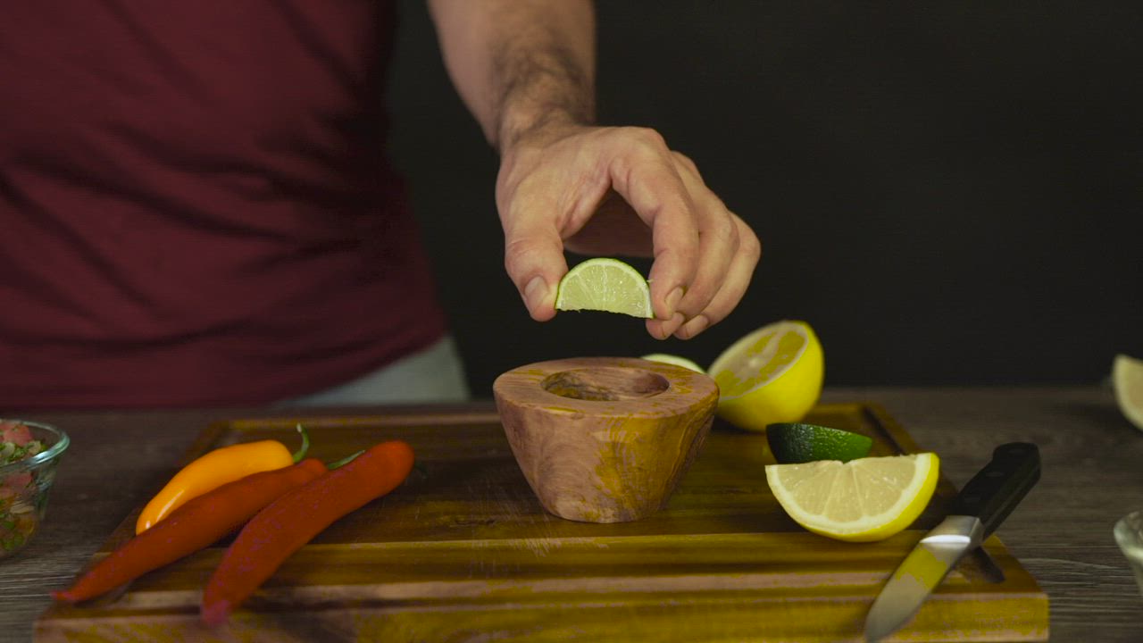 Squeezing lime into a bowl - Free Stock Video