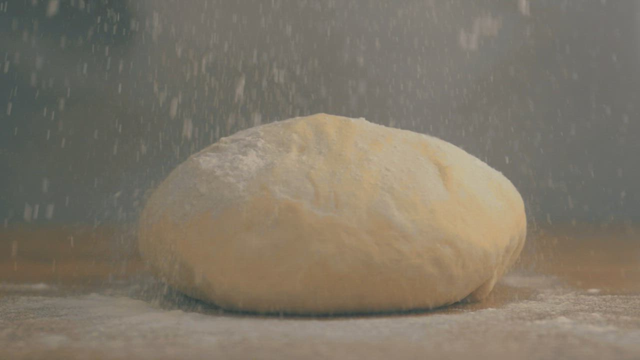 A chef covering dough with flour - Free Stock Video