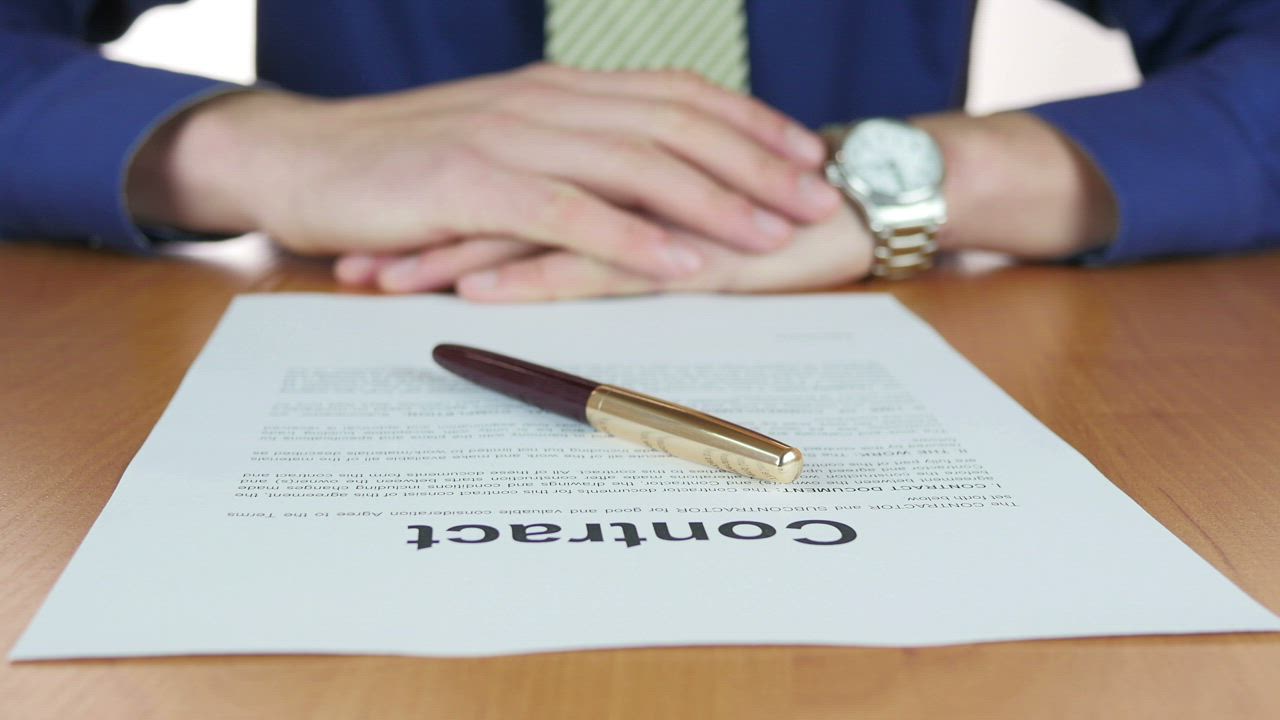 Signing a contract with a pen - Free Stock Video