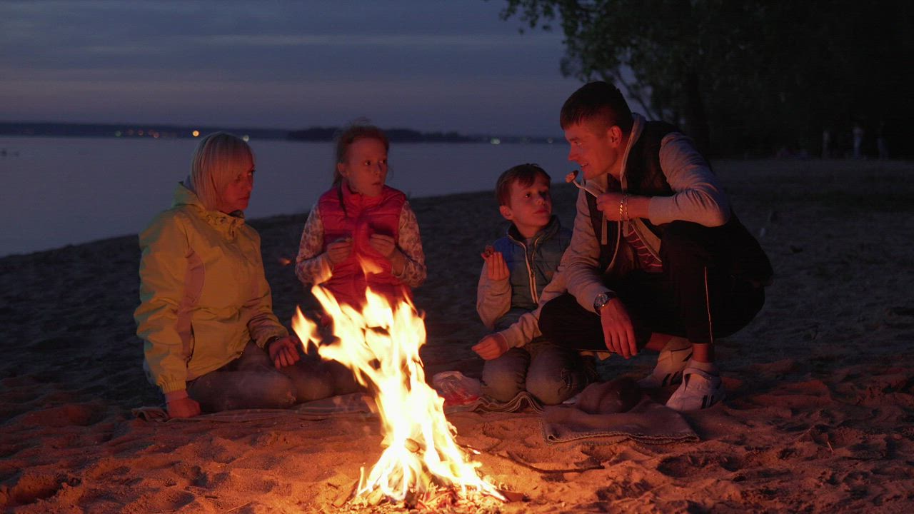 Family cooking over a campfire - Free Stock Video