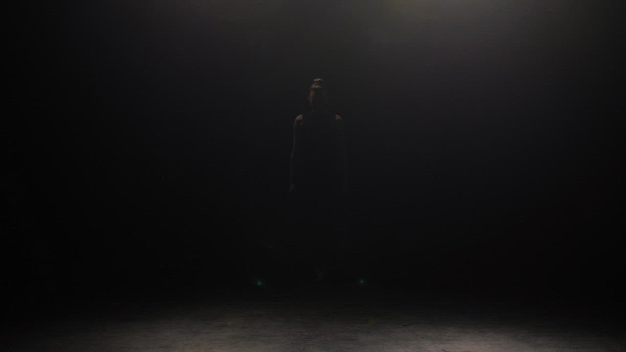 Expressive dance in a dark room - Free Stock Video