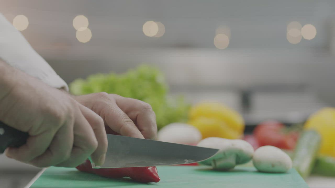 Chopping up vegetables in a kitchen - Free Stock Video