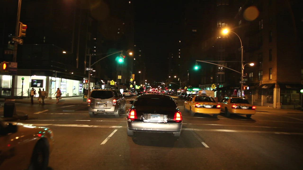 Taxis driving through the streets at night - Free Stock Video