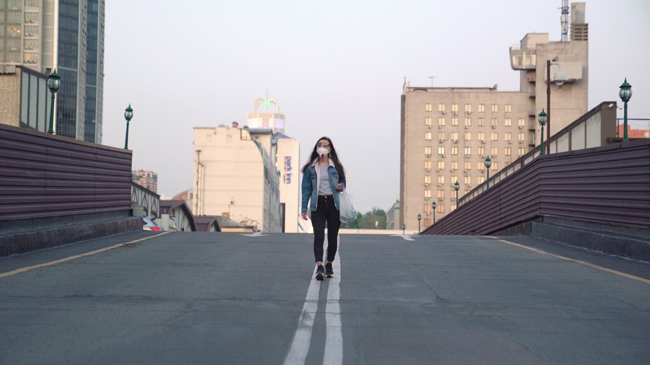 A woman walking in the middle of an empty street - Free Stock Video