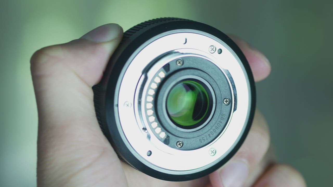 Hand holding a camera lens - Free Stock Video