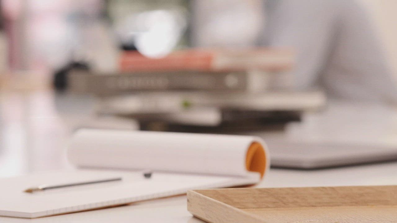 At a cafe making notes in a book - Free Stock Video