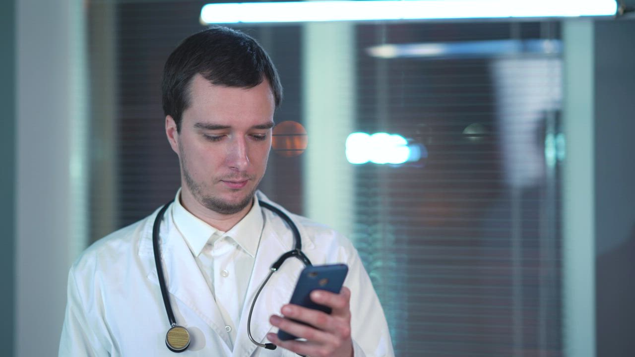 Doctor using phone in the hospital - Free Stock Video