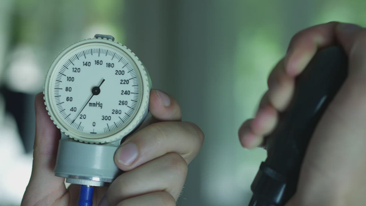 Doctor's hands measuring the pressure - Free Stock Video