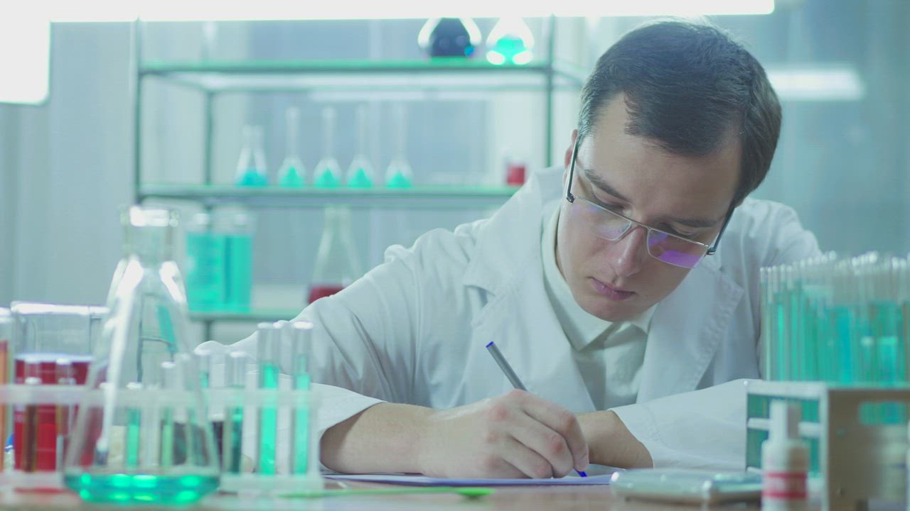 Scientist writing in the lab - Free Stock Video