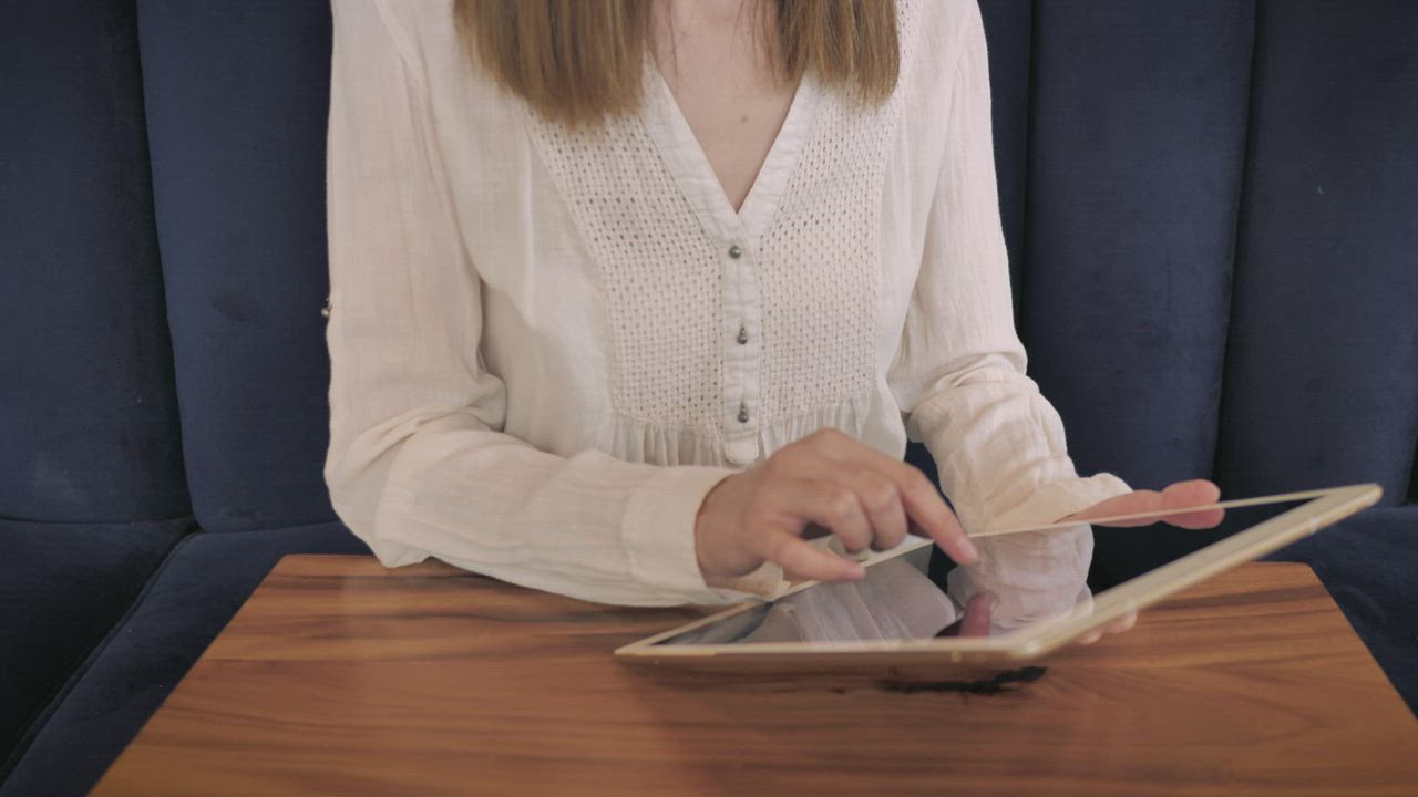 Woman using a tablet on the couch - Free Stock Video