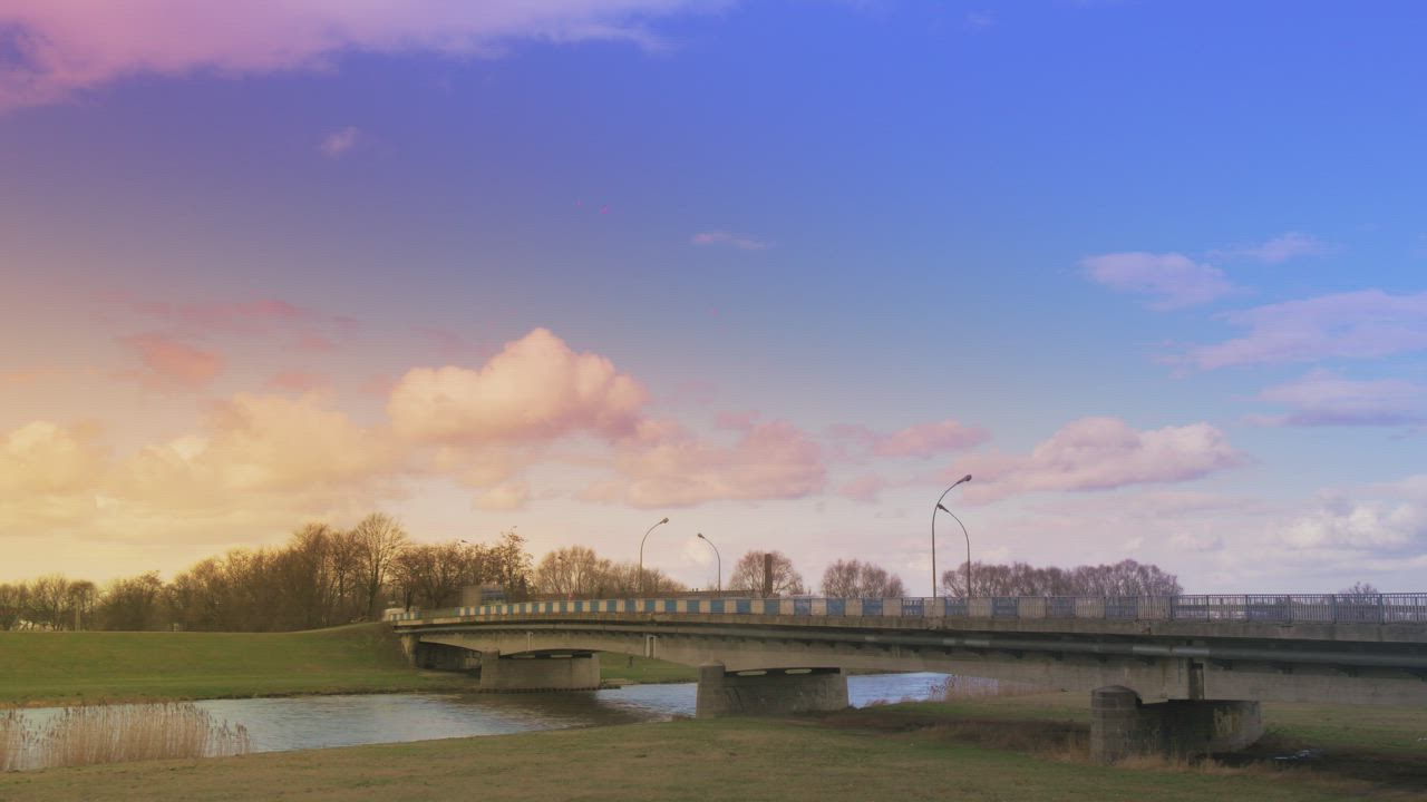 Bridge with traffic in the countryside at sunset - Free Stock Video