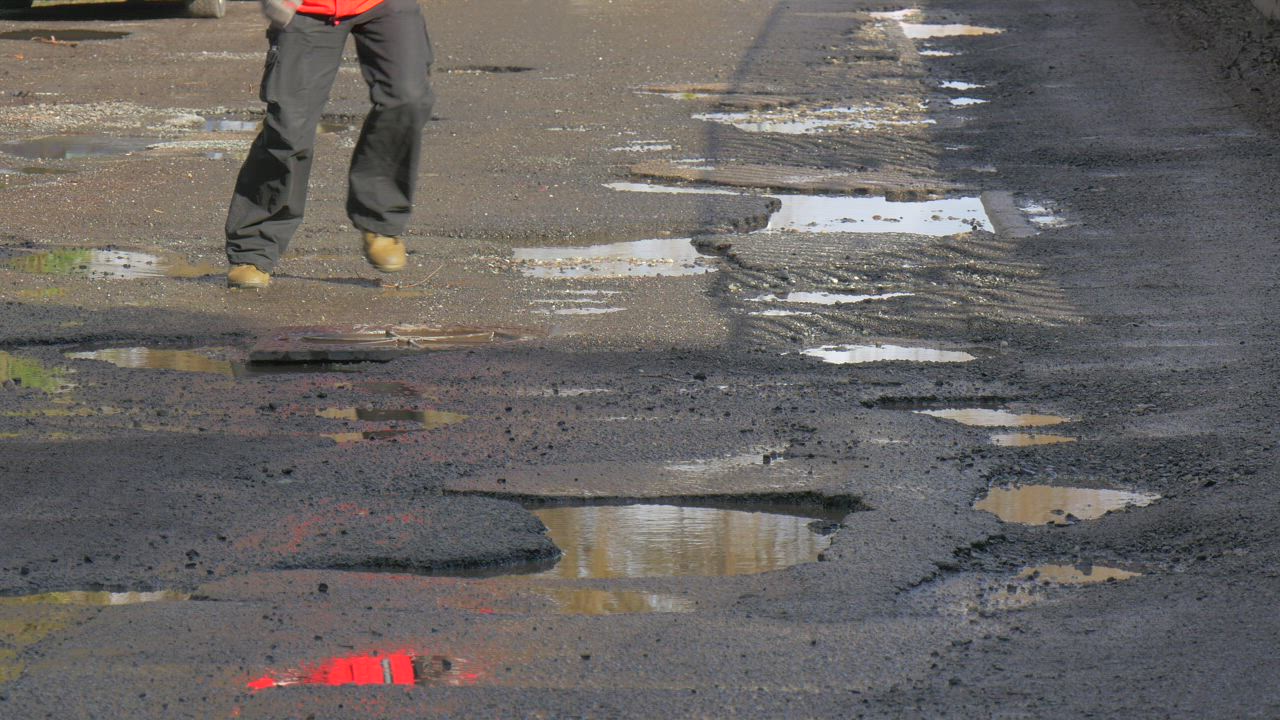 Man walking in a street filled with bumps - Free Stock Video