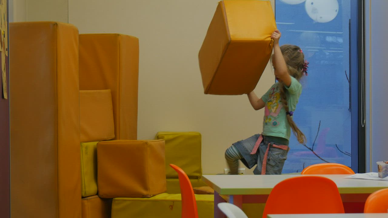 Little girl building a wall at school - Free Stock Video