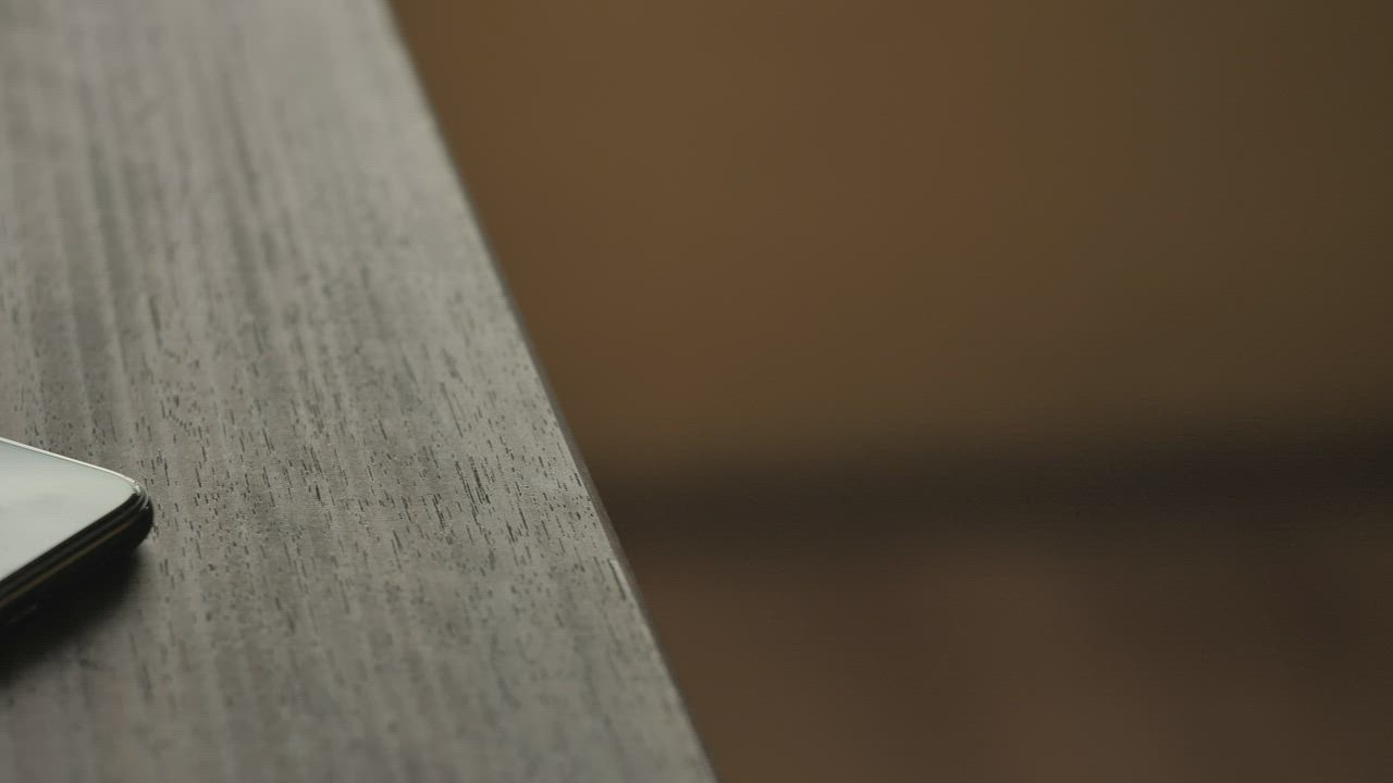 Smartphone on a wooden table - Free Stock Video