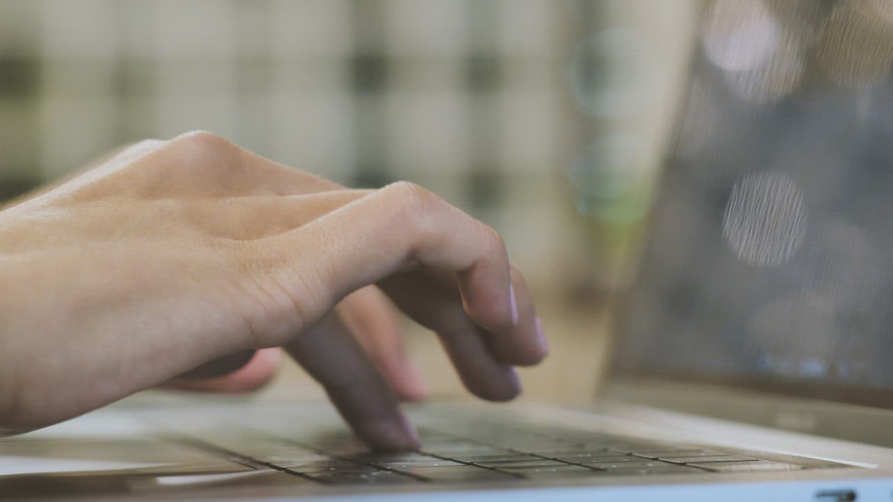 Fingers tapping away on a laptop keyboard - Free Stock Video