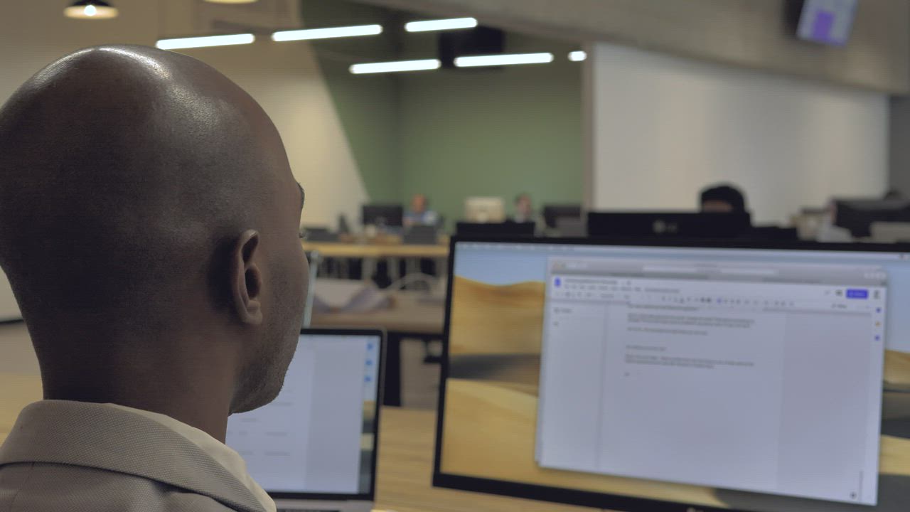Office person working on a computer - Free Stock Video