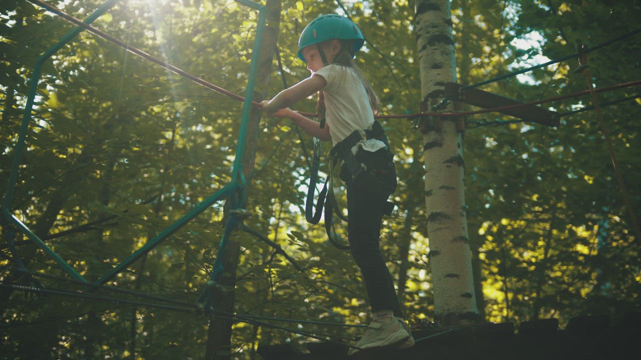 Girl crossing the ropes in the woods - Free Stock Video