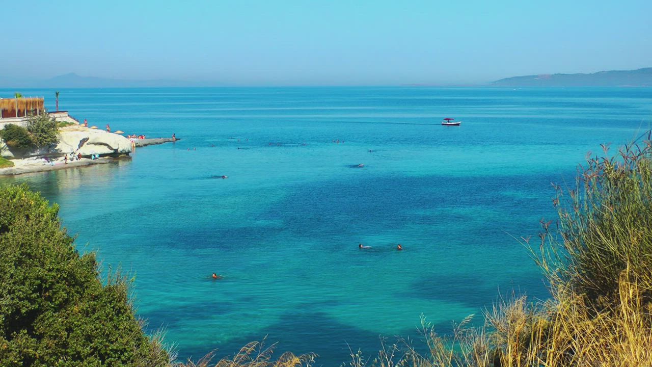 Tourist beach with clear water sea, high view - Free Stock Video