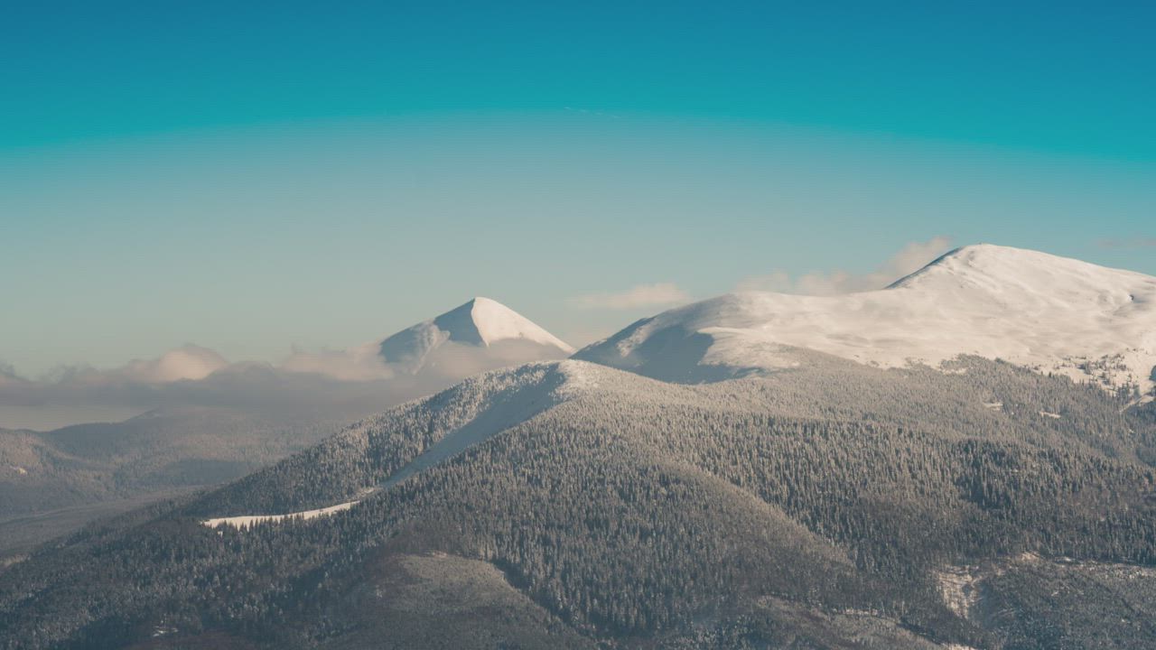 Zoom out of a mountainous area in winter - Free Stock Video