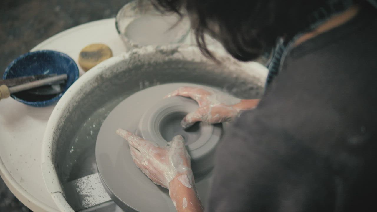 Woman using pottery wheel - Free Stock Video