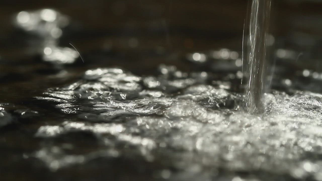 Water dripping into a pool - Free Stock Video