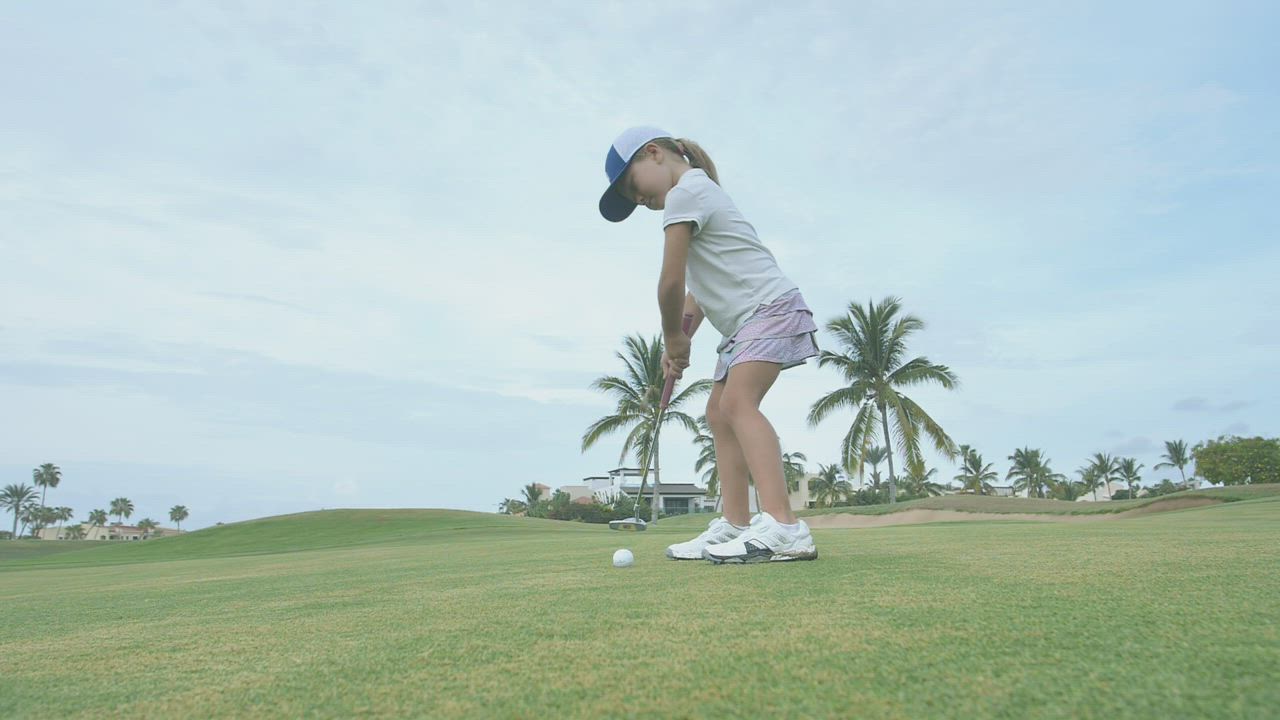 Girl hitting a golf ball - Free Stock Video