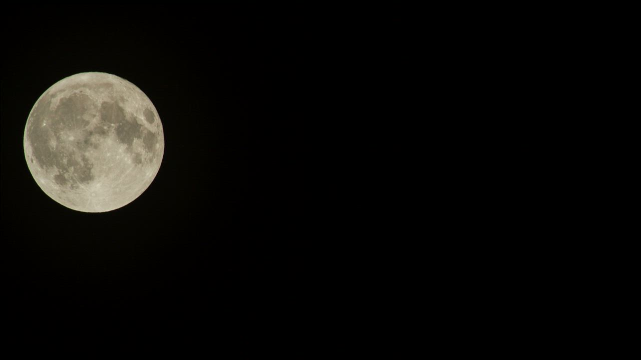 Full Moon heading across the night sky - Free Stock Video