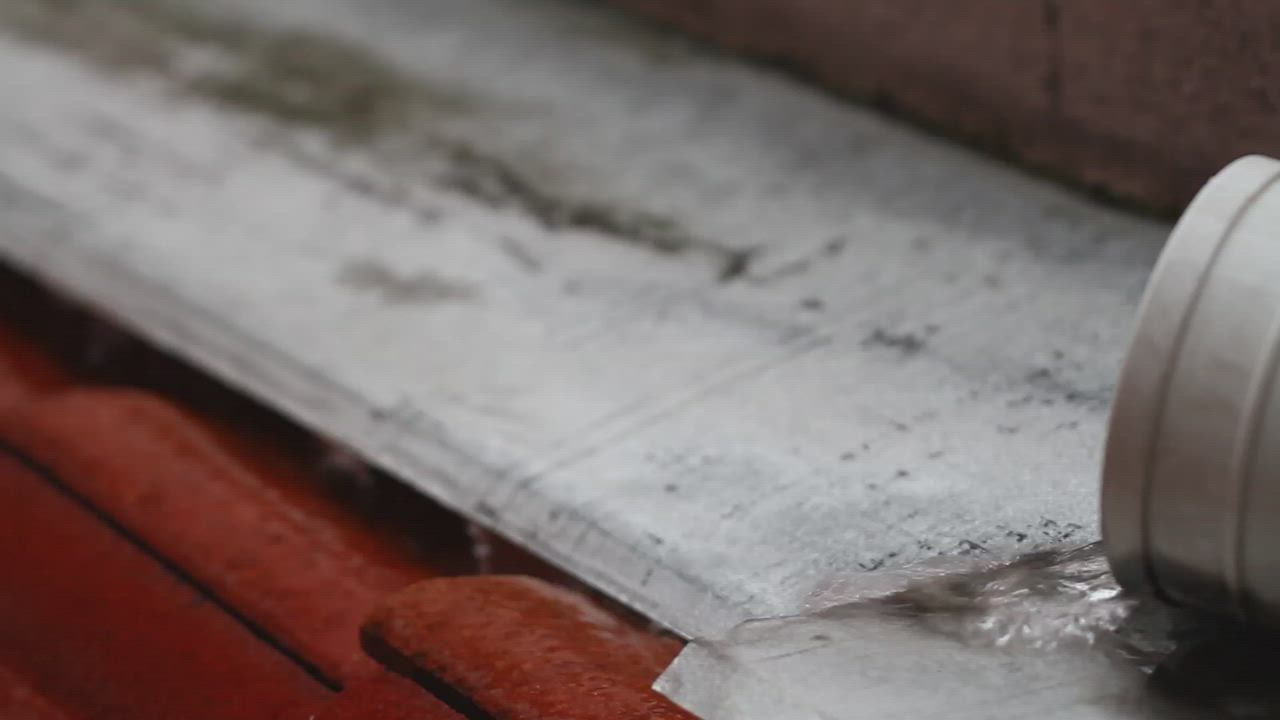 Rain water running into a gutter - Free Stock Video