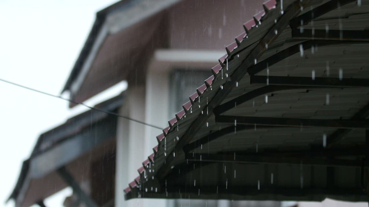 Rain falling off of a rooftop - Free Stock Video