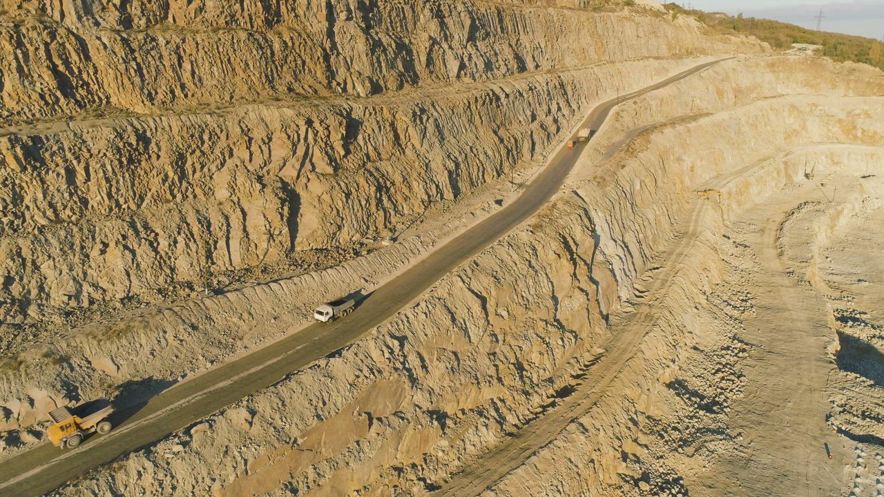 Trucks driving along a quarry road - Free Stock Video