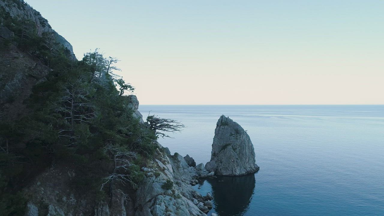 Rocky coast with calm water - Free Stock Video