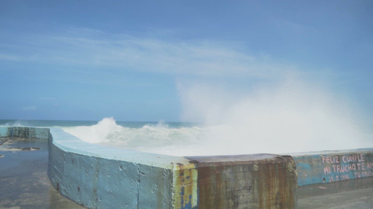 Waves breaking against a coastal wall - Free Stock Video