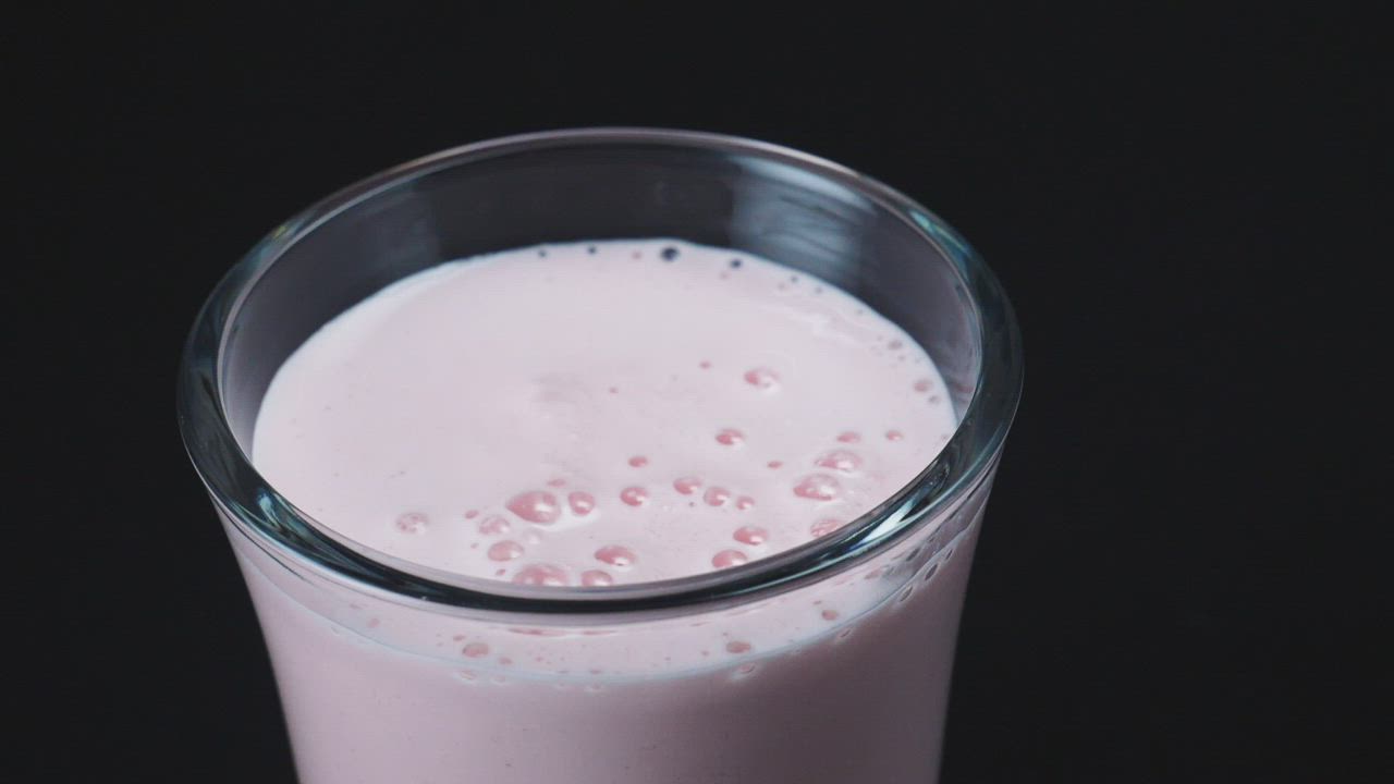 Dropping fruit into a milk shake - Free Stock Video
