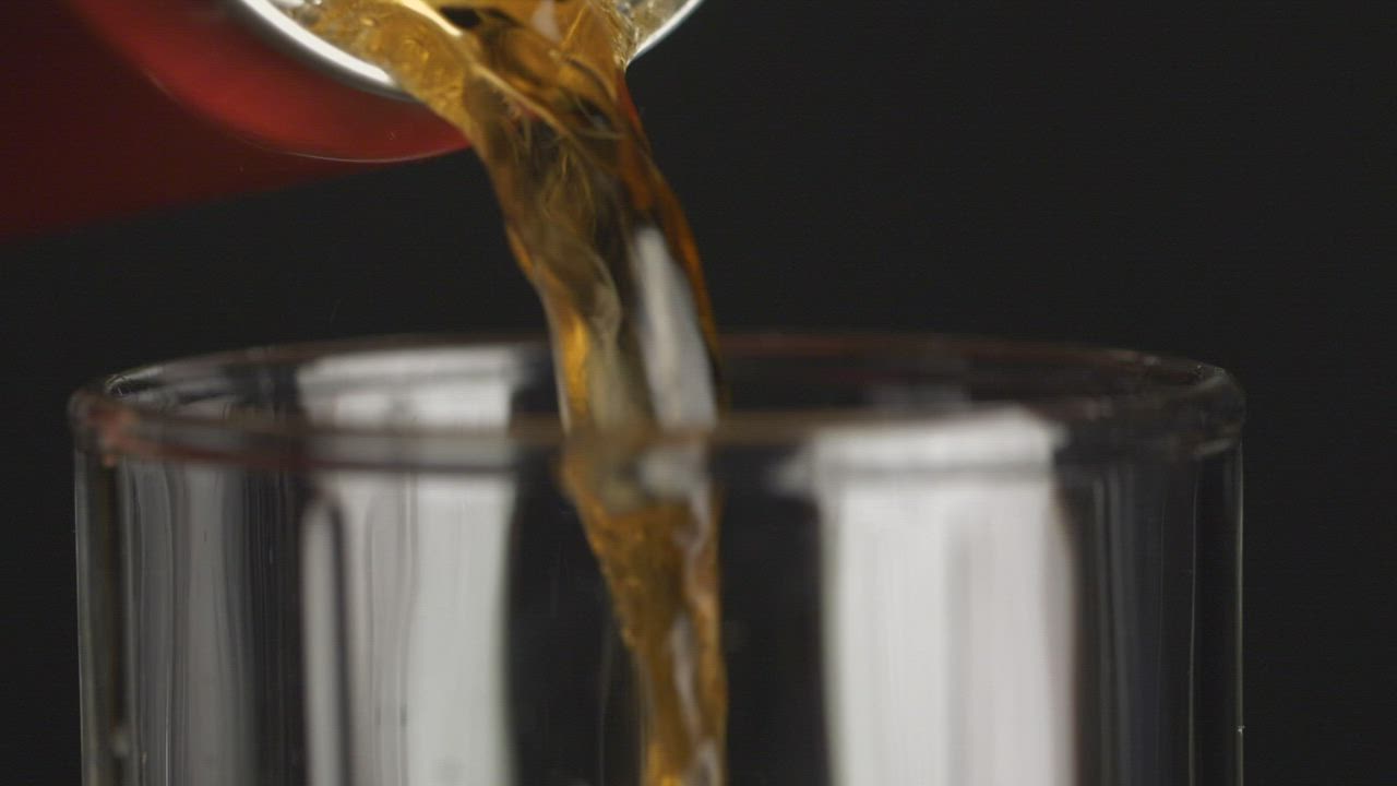 Pouring a can of soda into a glass - Free Stock Video