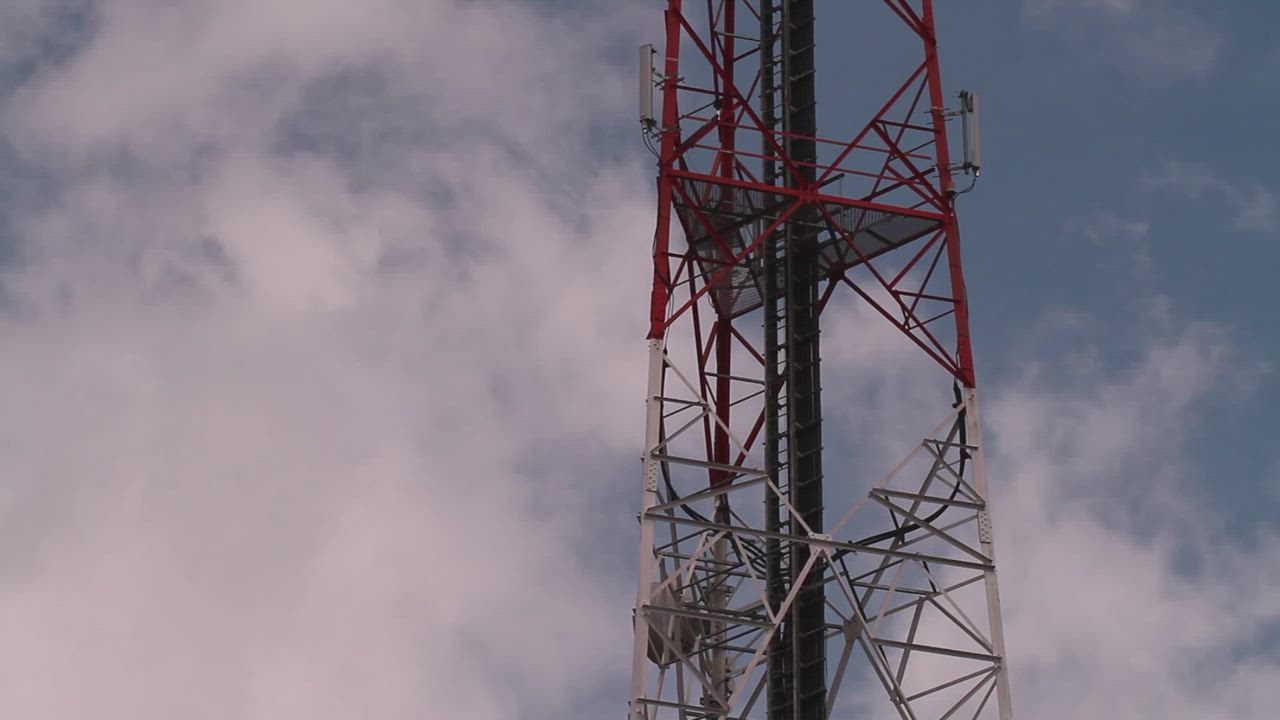 Red and white communications tower - Free Stock Video