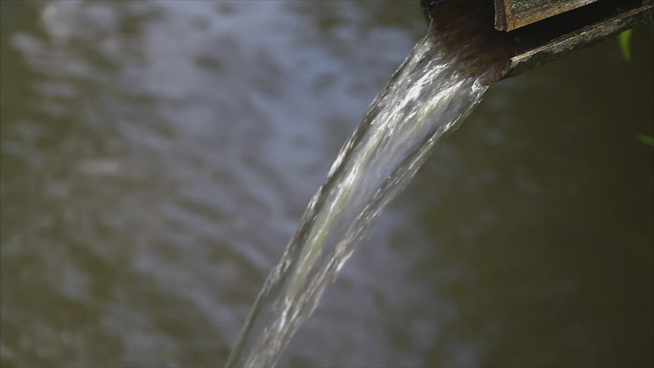Metal water fountain in a large pond - Free Stock Video