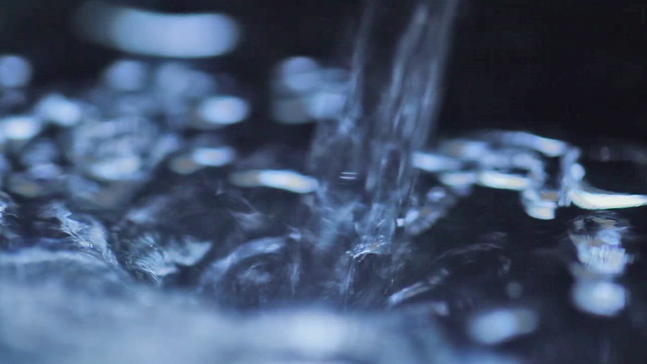 Pouring water into a large pool - Free Stock Video