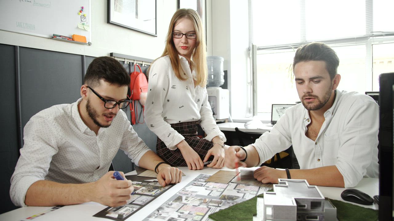 Group of architects discussing a building model - Free Stock Video