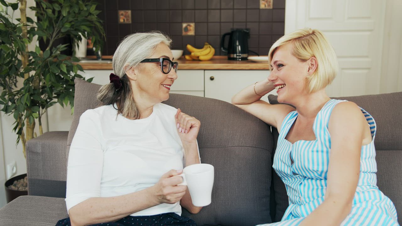 Mother and daughter talking in their living room - Free Stock Video