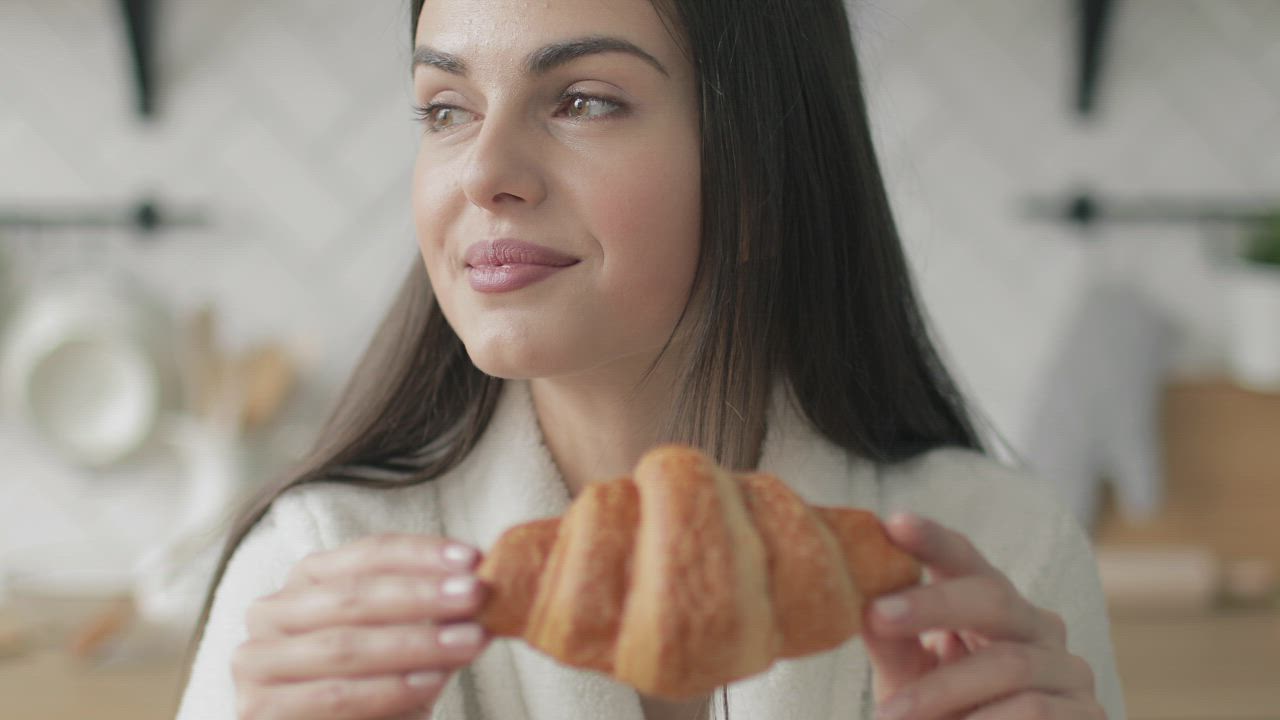 Woman about to eat bakery - Free Stock Video