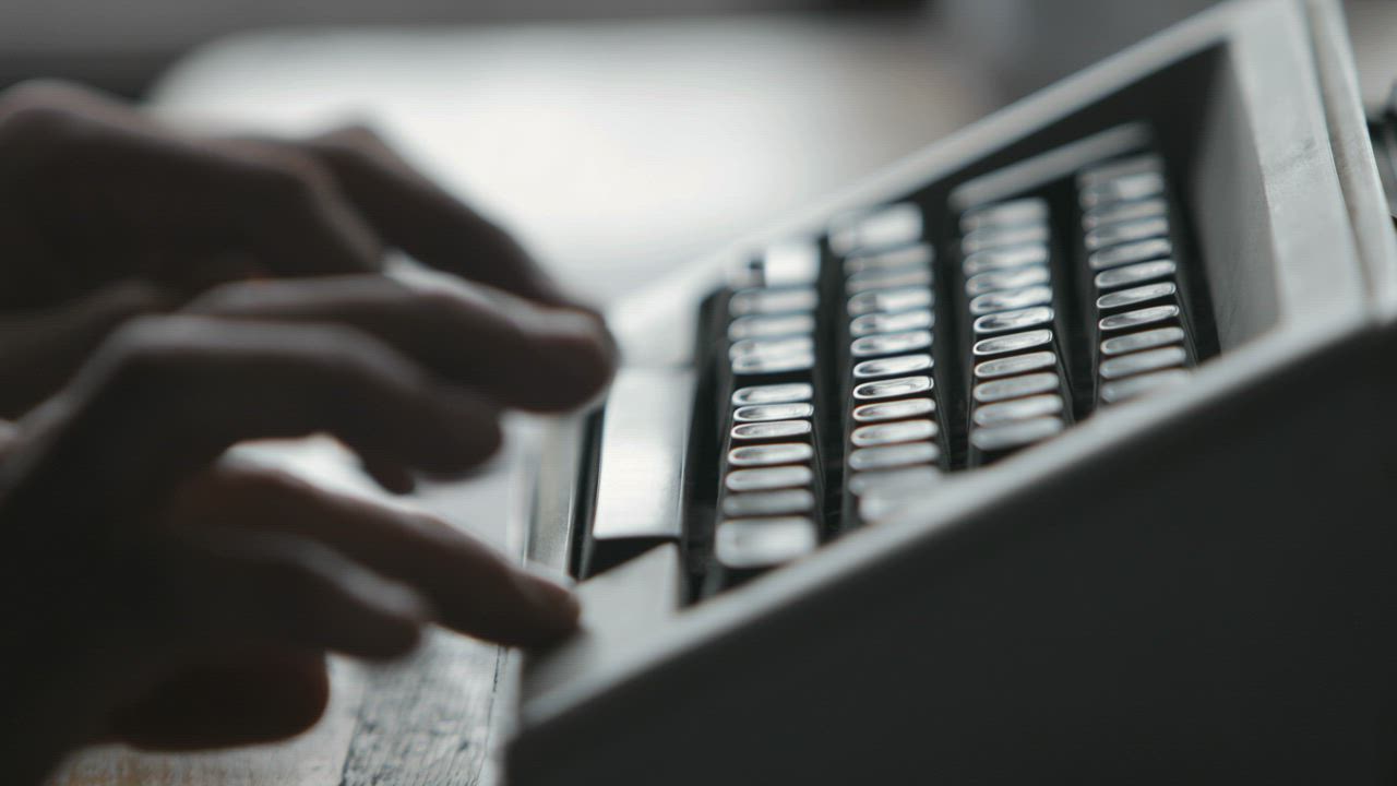 Person writing a letter with a typewriter - Free Stock Video