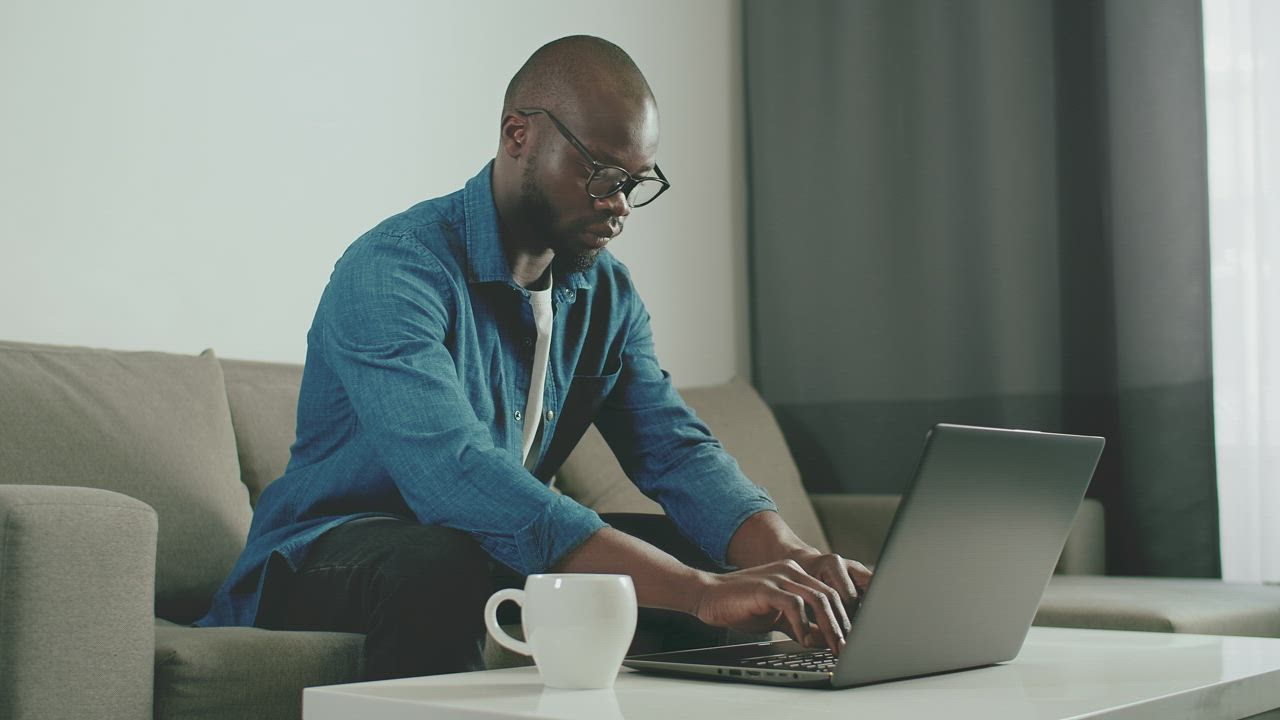 Man working from home in his living room - Free Stock Video