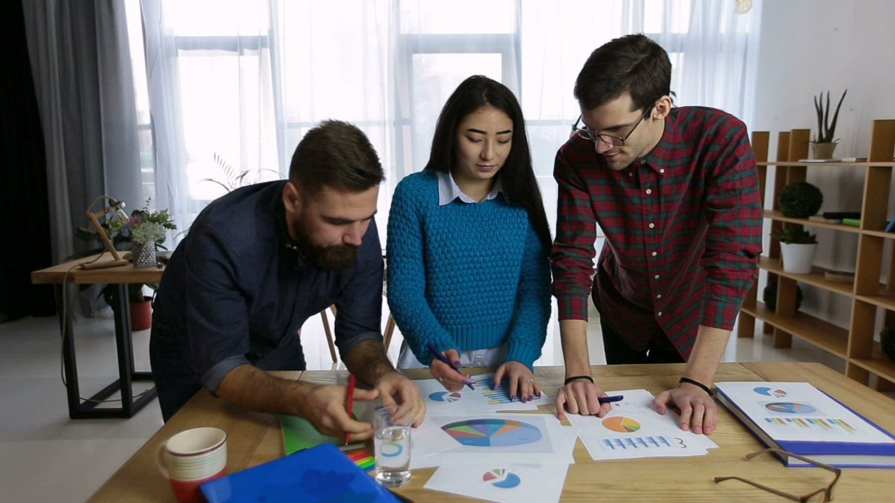 Team reviewing charts and reports - Free Stock Video