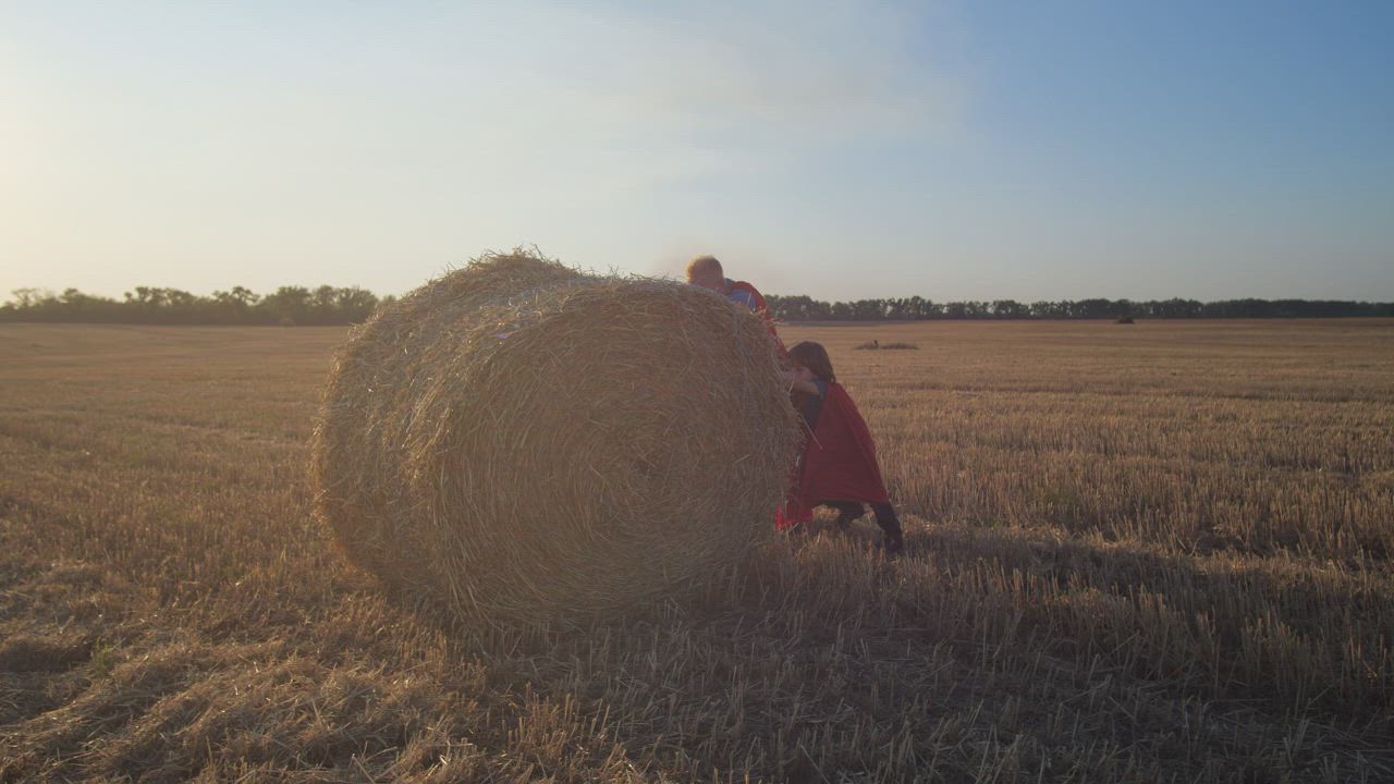 Rolling a huge bale of hay - Free Stock Video