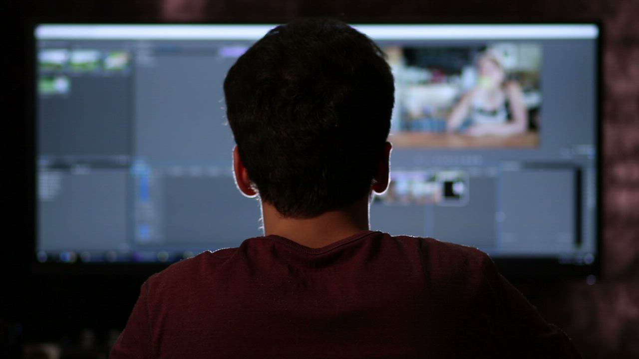 Video editor working on a large screen - Free Stock Video
