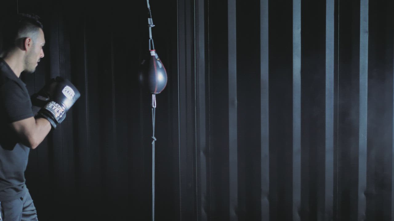 Boxer training with a punch ball - Free Stock Video
