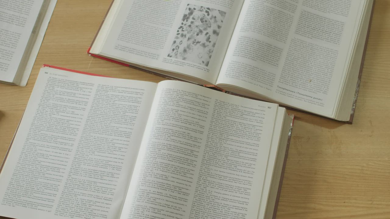 Books open wide for reading on a table - Free Stock Video