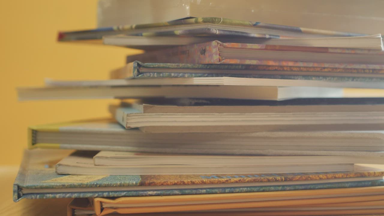 Detailed view of a disarranged tower of books - Free Stock Video