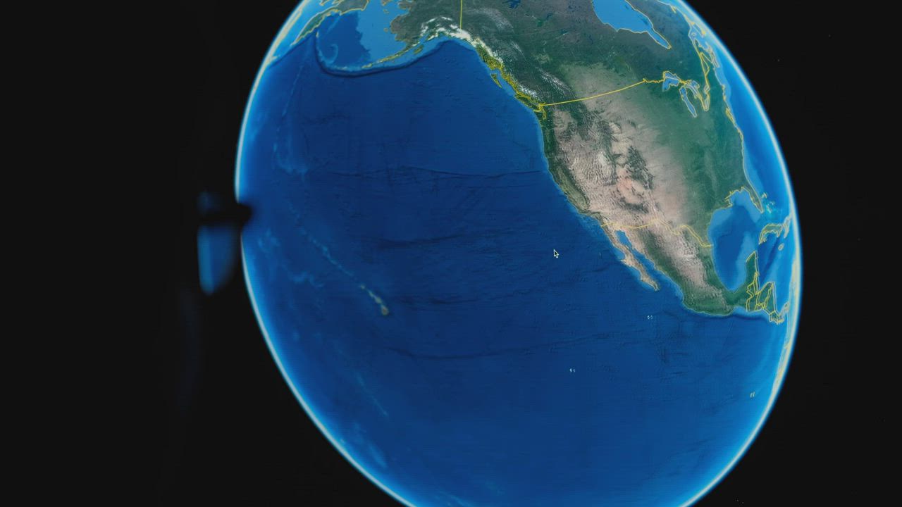 Man in front of a computer while using Google Earth - Free Stock Video