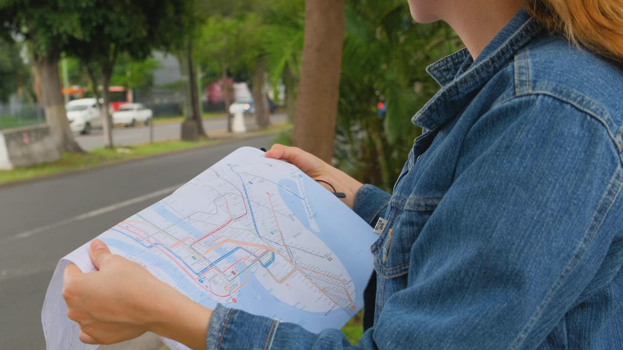 Woman on the street locating herself with a map of the city - Free ...
